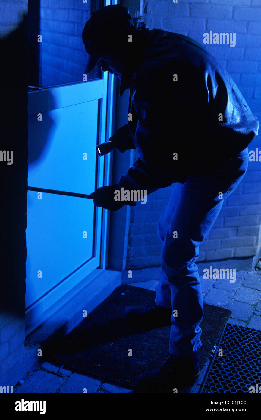 A man breaks into a house Stock Photo - Alamy