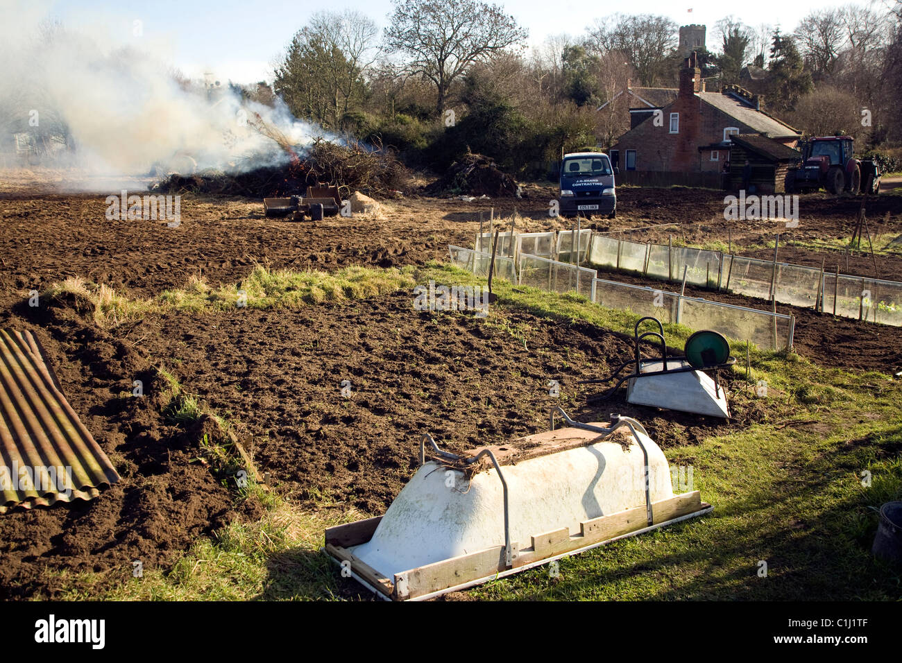 Contractor clearing land for new allotment bonfire Stock Photo - Alamy