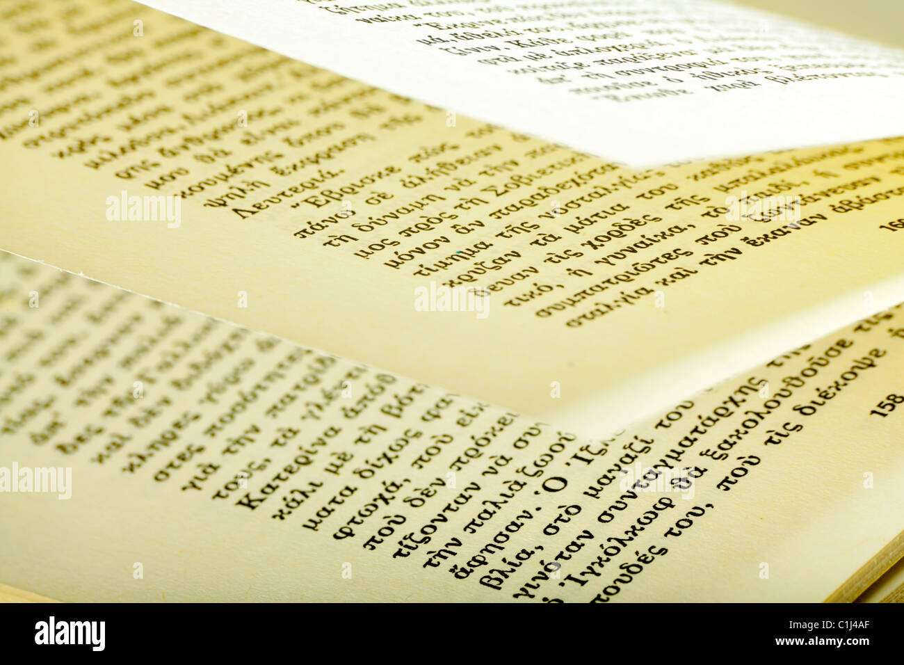 Open book with Greek text Stock Photo - Alamy