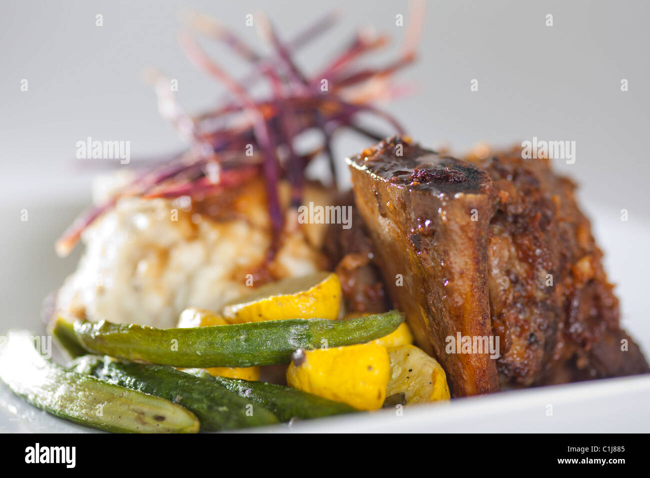 Ribs, mashed potatoes, grilled vegetables and shoe string potatoes ...