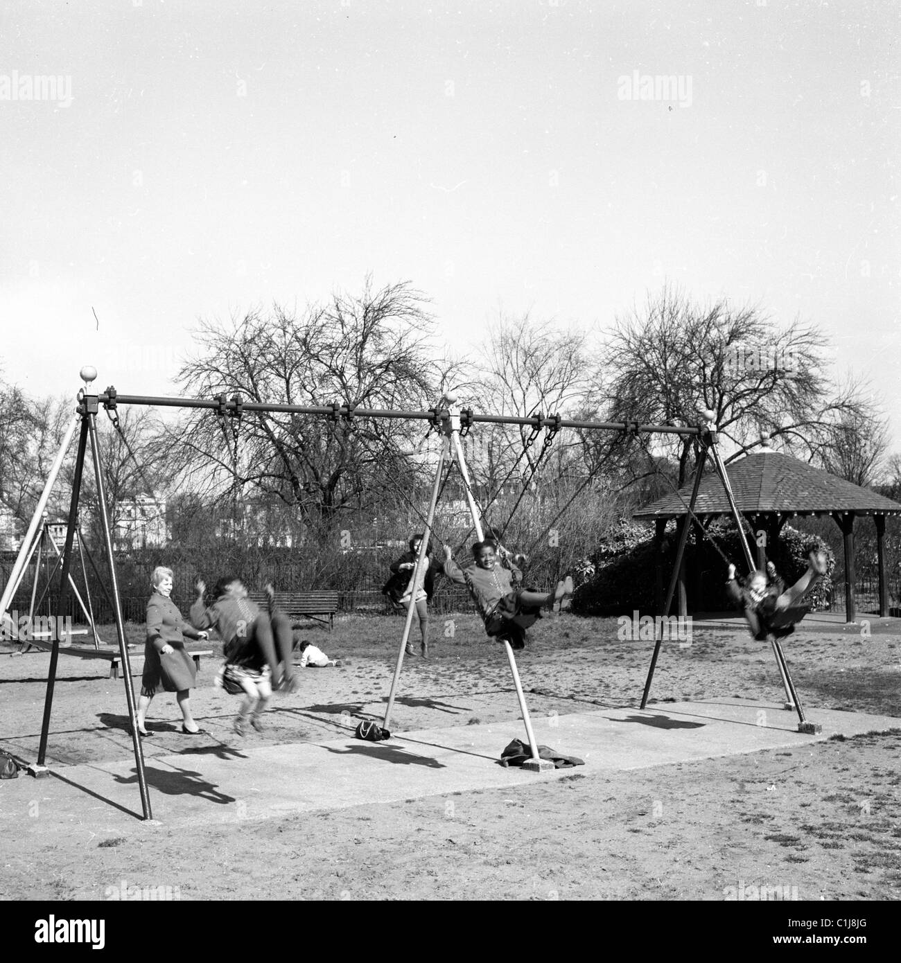 1950s, historical, four school children at a playground playing on the ...