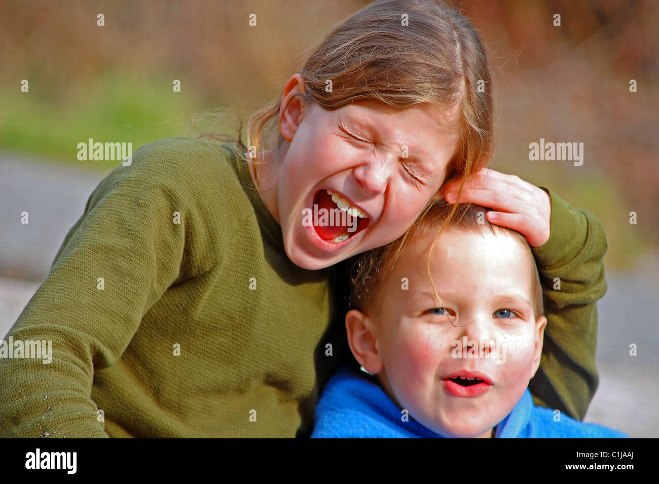 Candid silly moment between siblings make this a unique photo of a ...