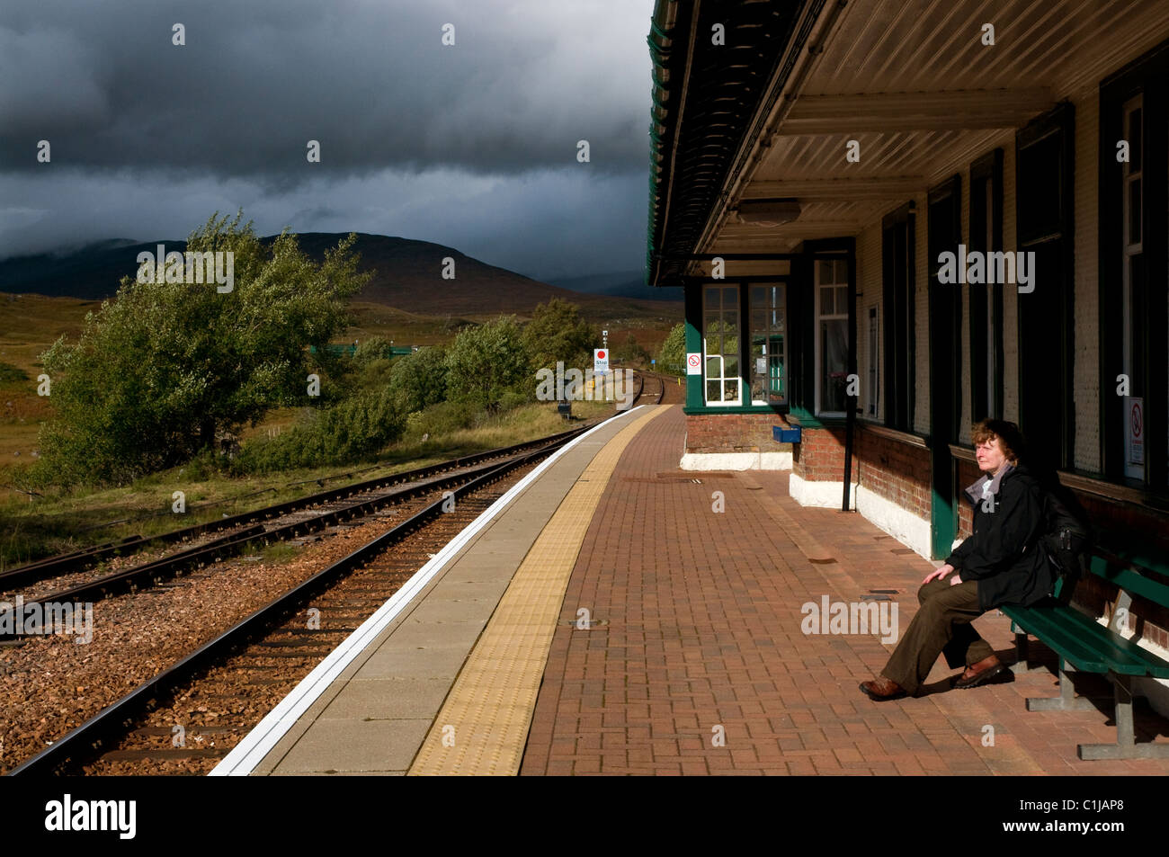 single passenger waiting for a train on the isolated rannoch station in ...