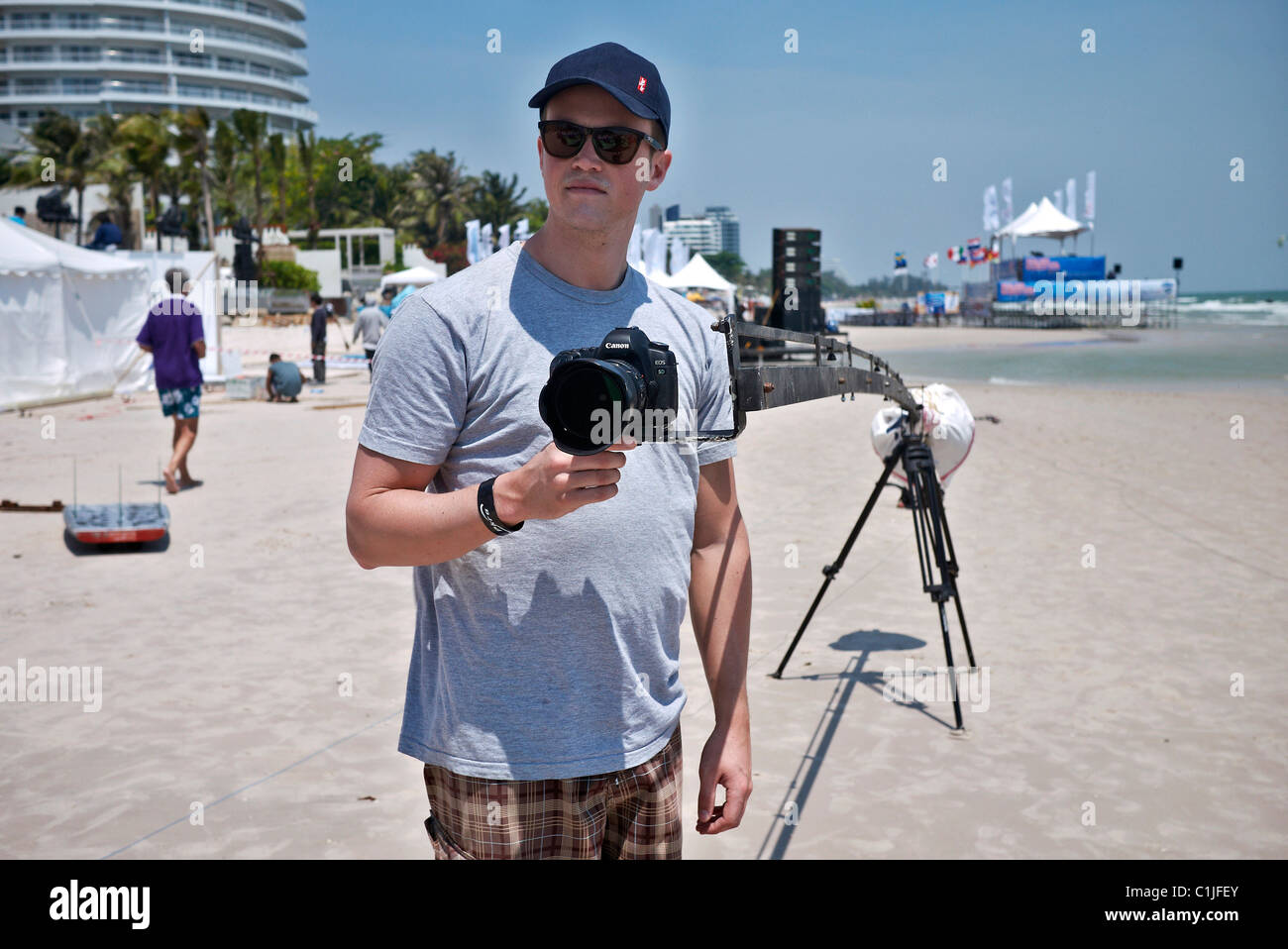 Camera boom. Beach photographer using a camera boom for elevated views ...