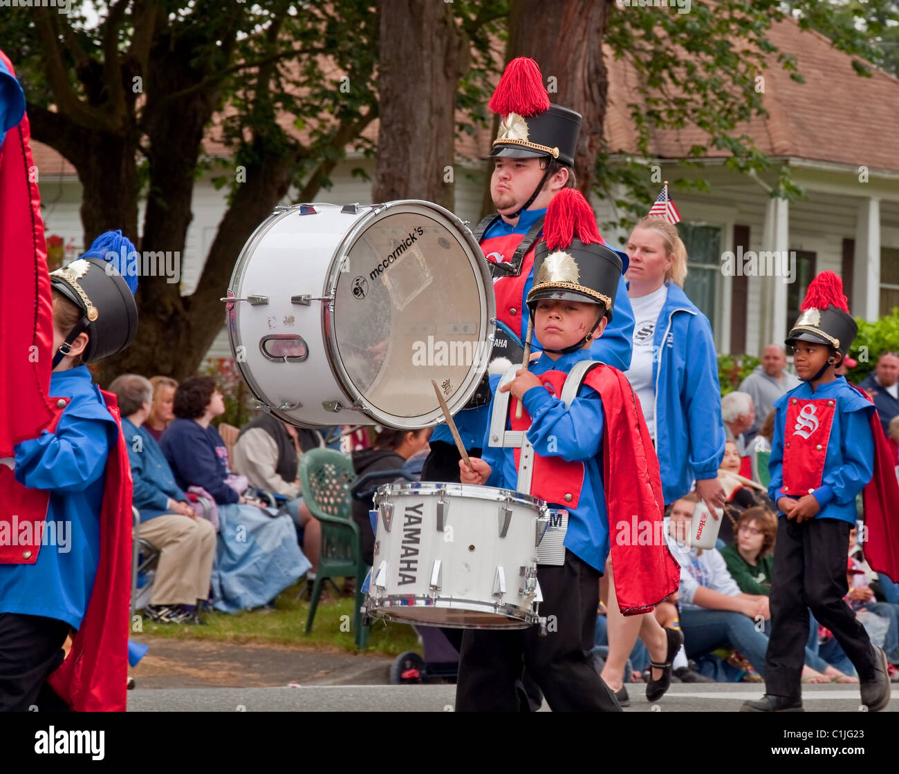 This stock image has a young drummer boy performing in a marching band ...