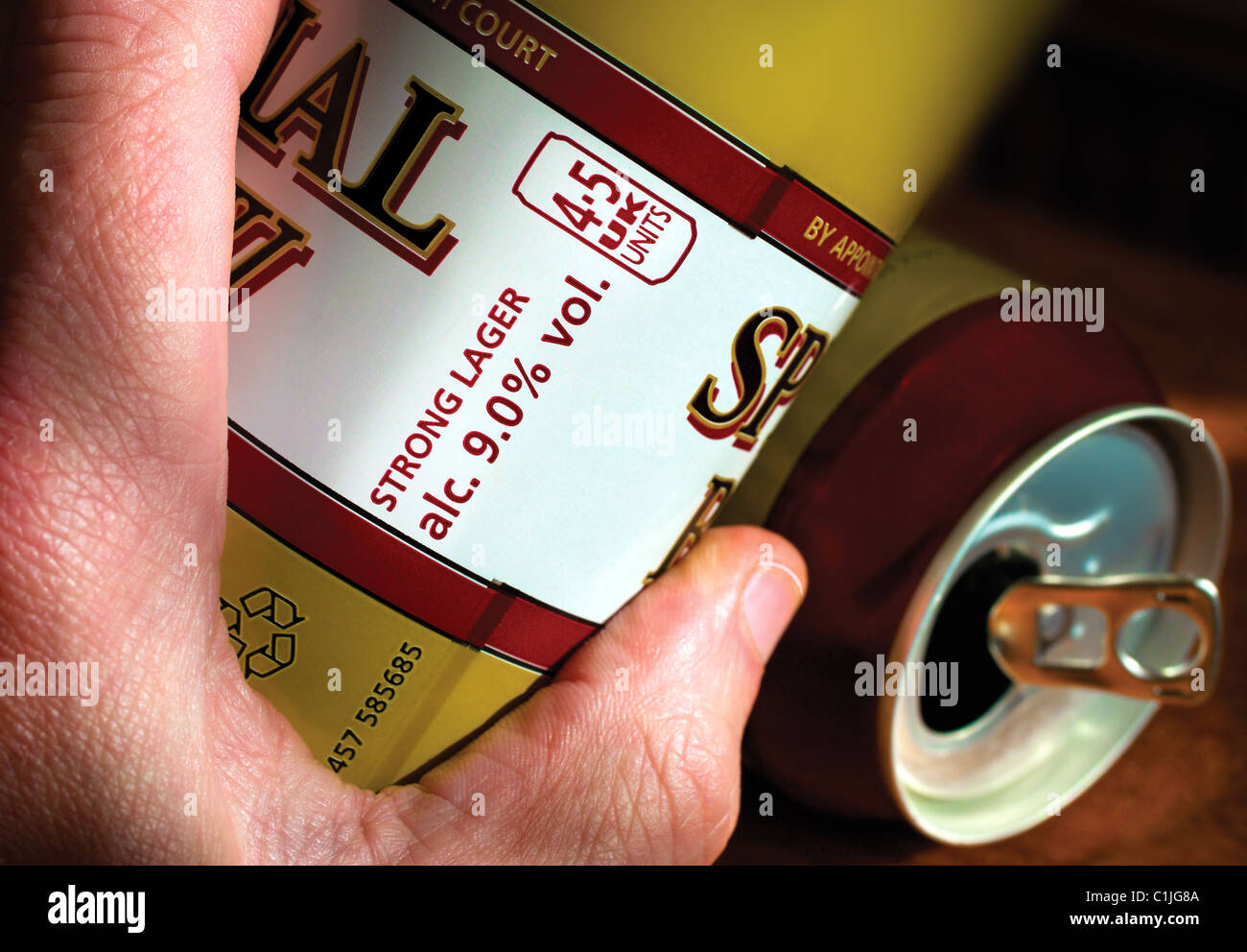 Hand holding tin of strong lager beer Stock Photo - Alamy