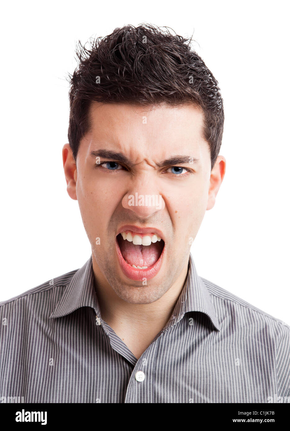Portrait of a angry young man yelling, isolated on white background ...
