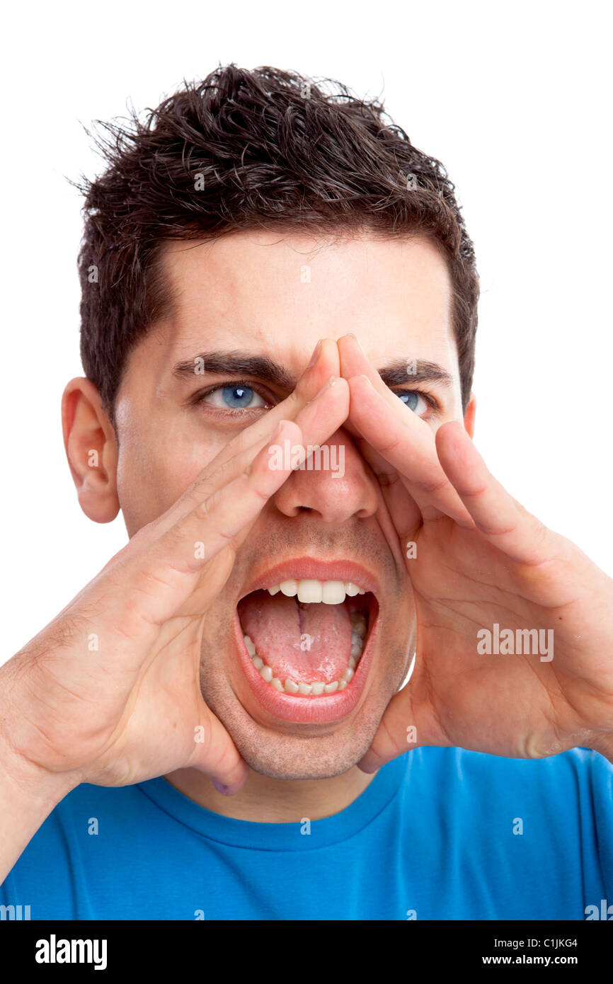 Portrait of a young man shouting loud with hands on the mouth, isolated ...