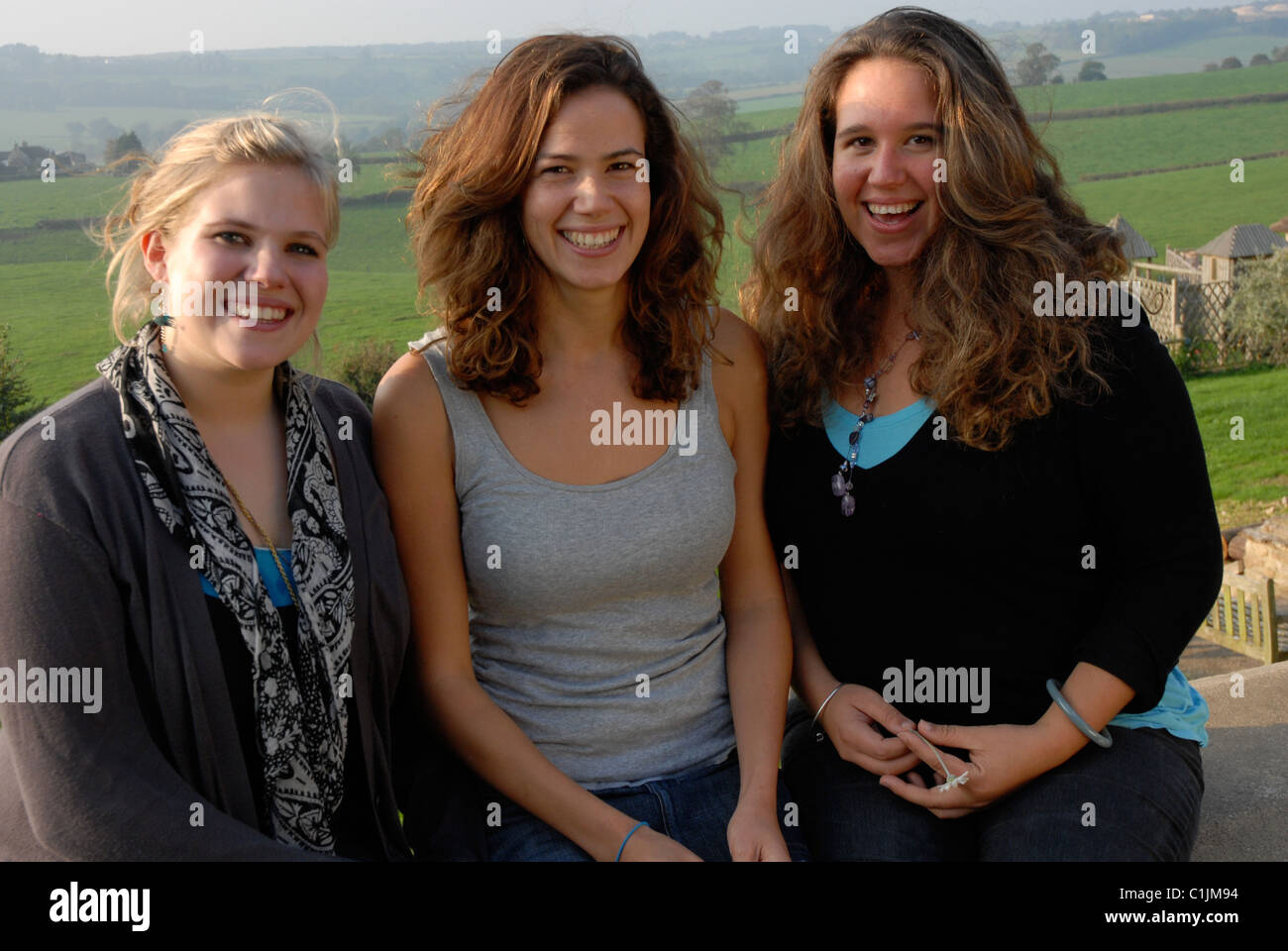 Portrait of three sisters together smiling Stock Photo - Alamy