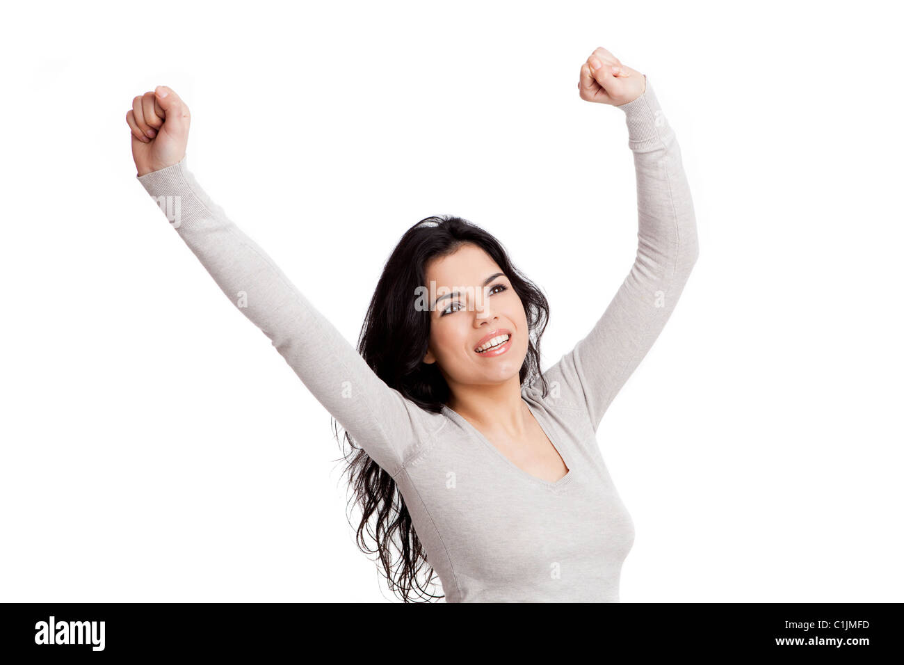 Happy young woman with arms up, isolated against a white background ...