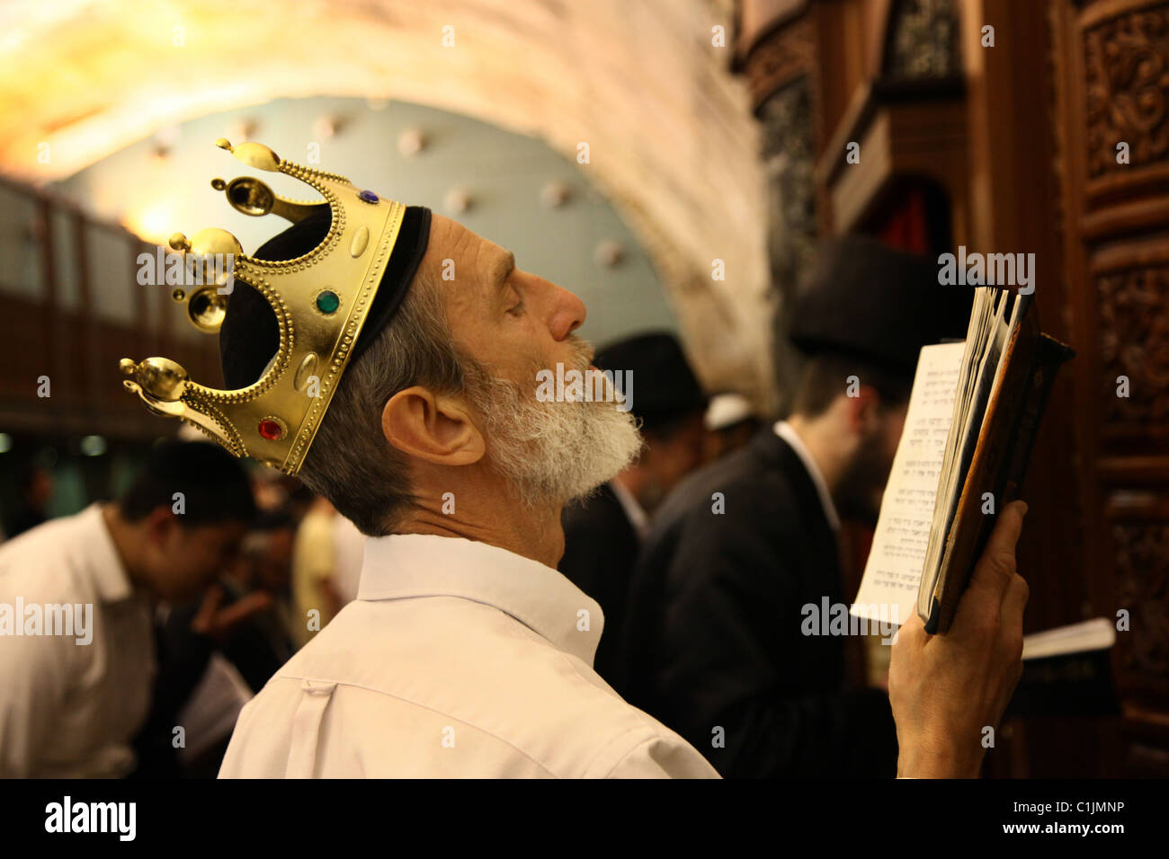 An Ultra Orthodox Jew wears a royal king costume as he reads the ...