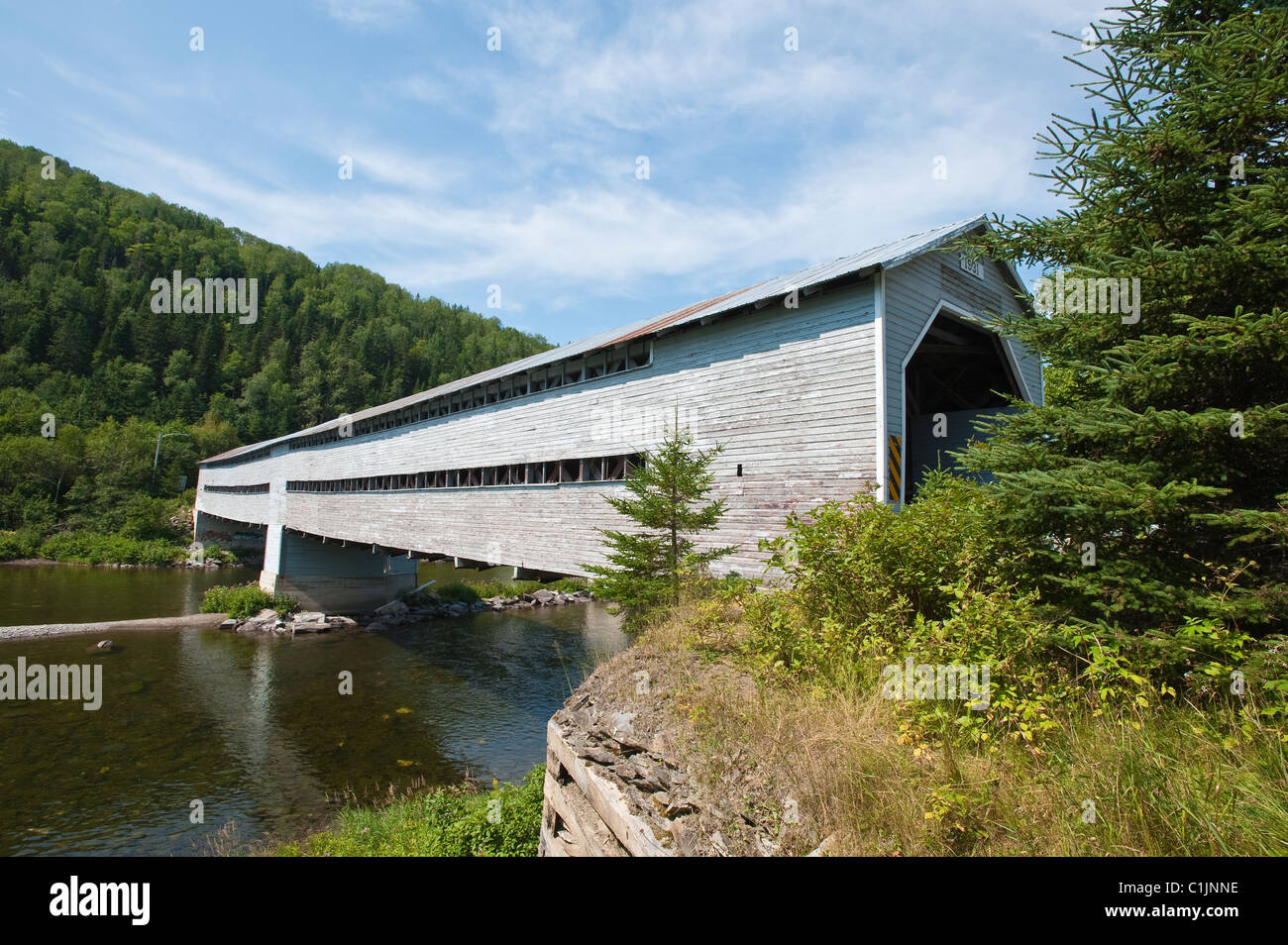 Quebec, Canada. De Routheirville covered bridge over the Matapédia ...