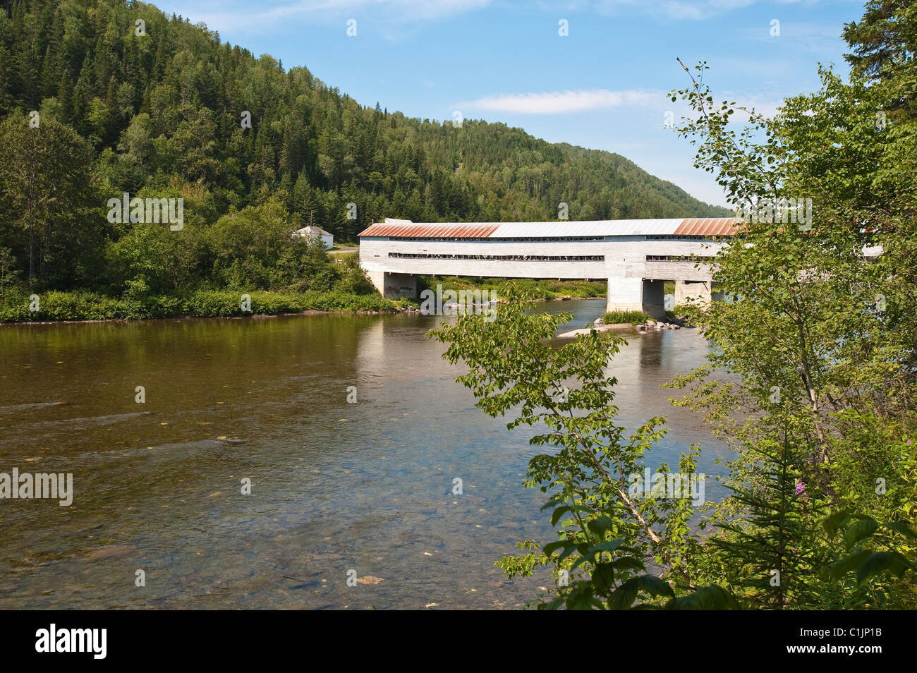 Quebec, Canada. De Routheirville covered bridge over the Matapédia ...