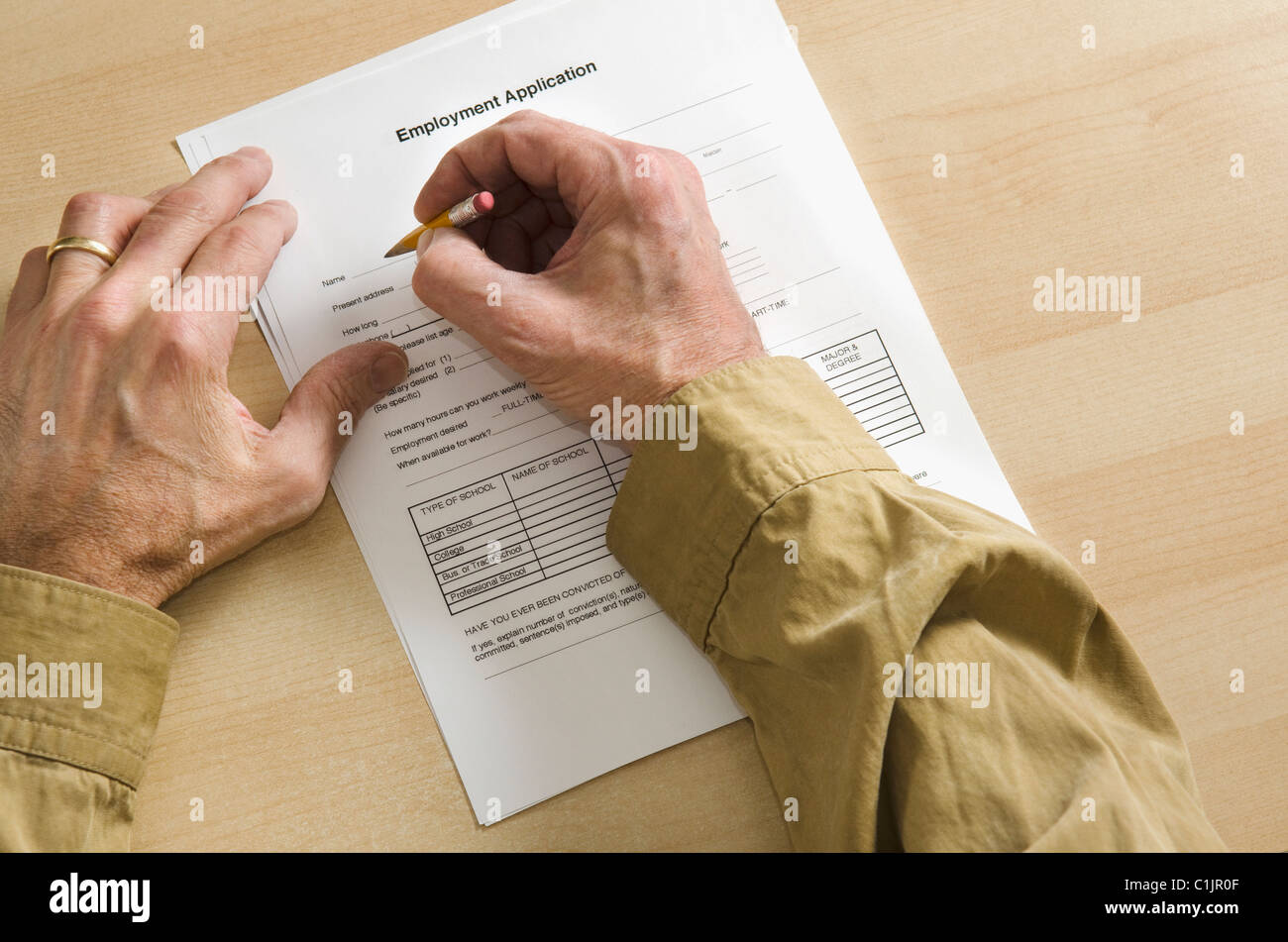 man with employment application holding small pencil Stock Photo - Alamy
