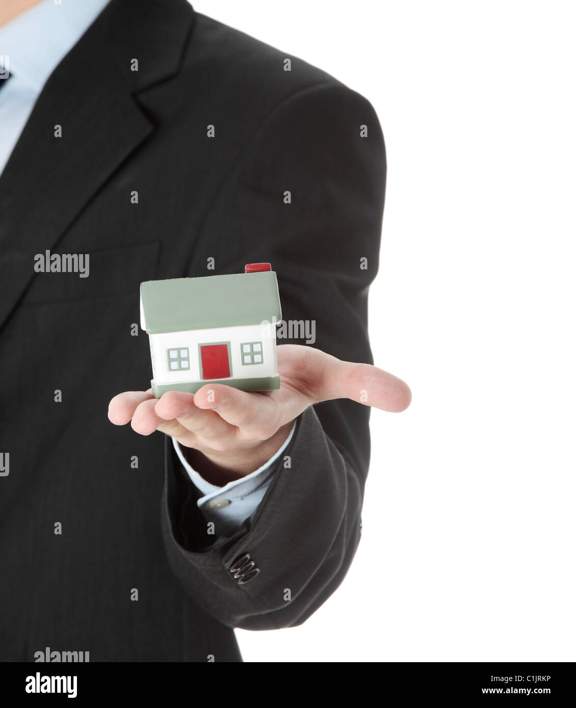 Young business man with house model on hand- real estate concept ...
