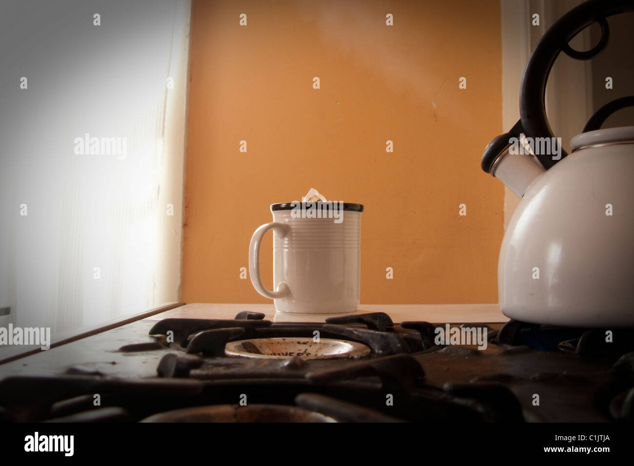 tea pot, cup, and steam on stove Stock Photo - Alamy