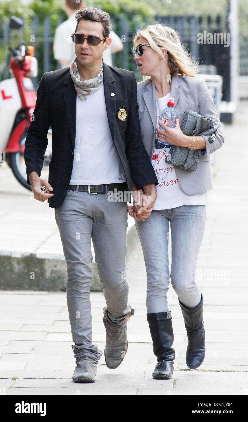 Kate Moss and Jamie Hince looking very much in love as they hold hands ...