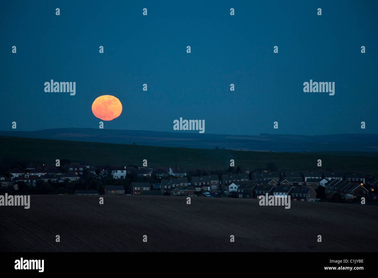 Full perigee moon rising over suburban houses Stock Photo - Alamy