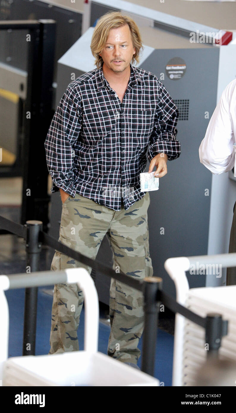 David Spade goes through airport security before boarding an American ...