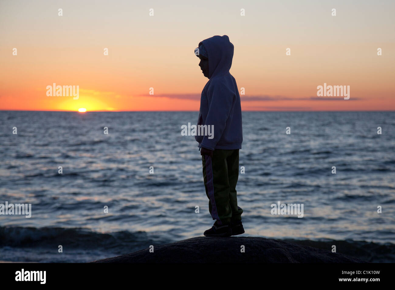 Kid Standing, Silhouette at Sunset Stock Photo - Alamy