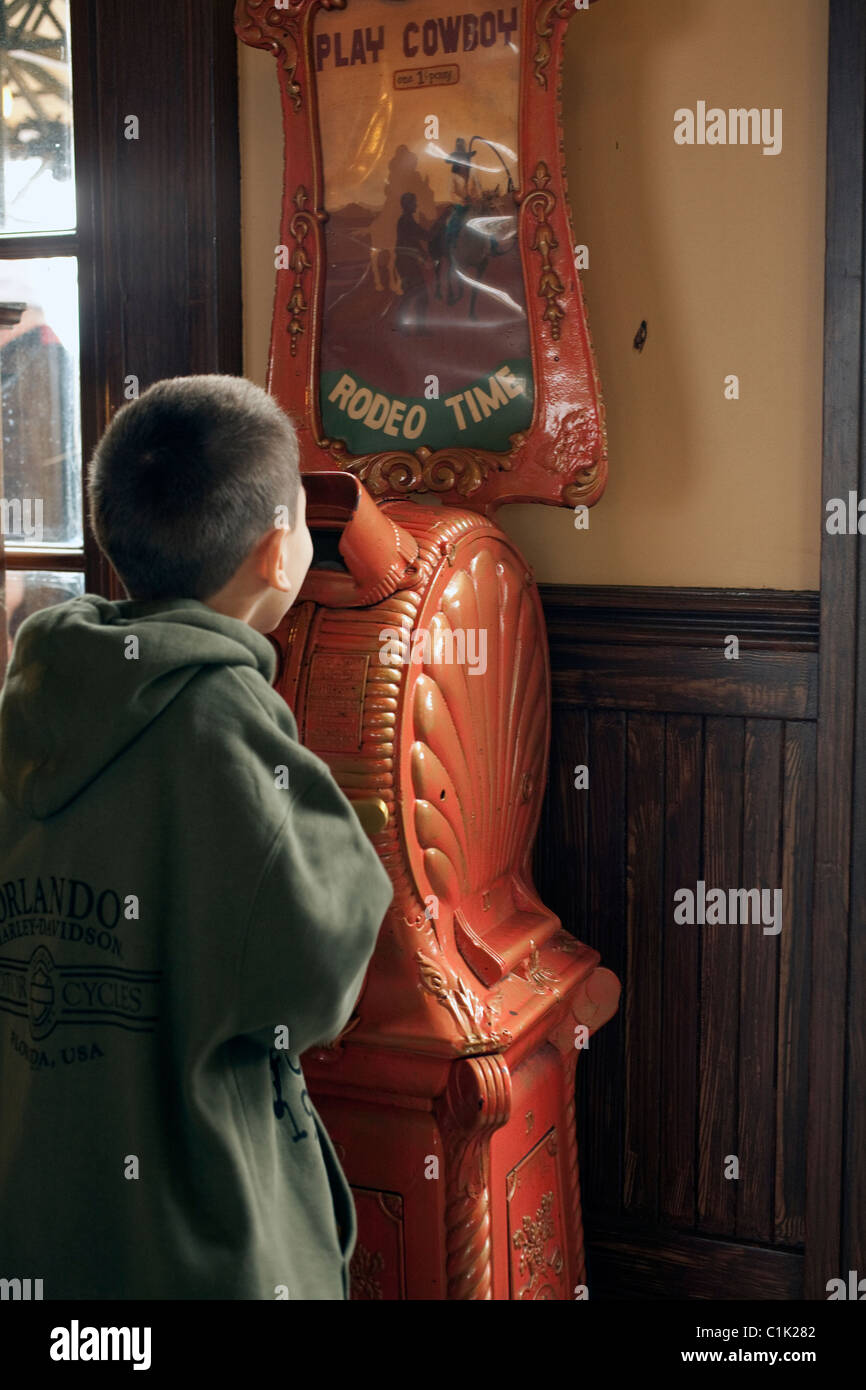 A young boy enjoys what he sees in the Disney World antique Mutoscope ...