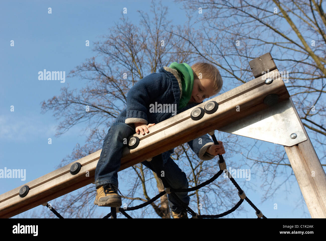 A child blond boy 4 years on a playground, spring park Stock Photo - Alamy