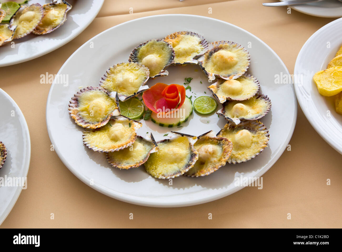 Plate of scallops with melted cheese Stock Photo - Alamy