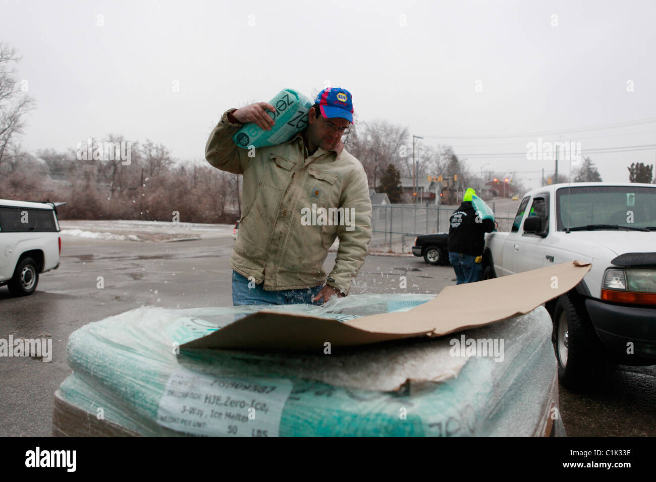 A customer at Kleindorfer's Hardware carries ice melting salt to a ...