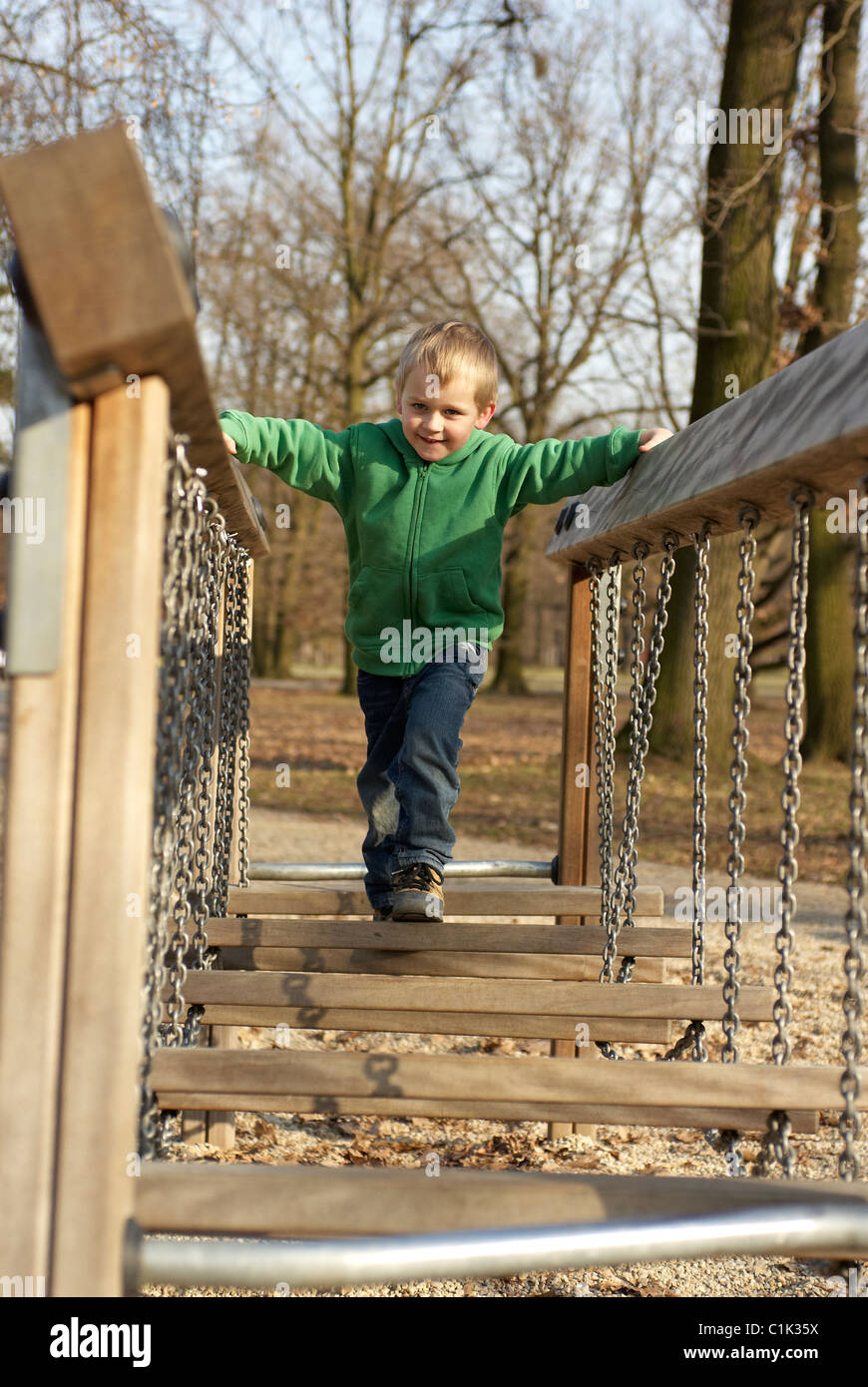 A child blond boy 4 years on a playground, spring park Stock Photo - Alamy
