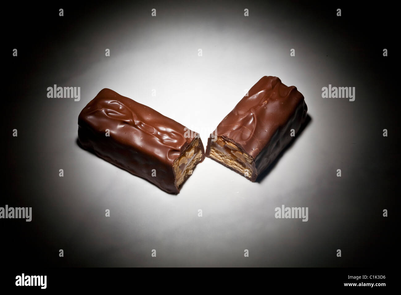 cut open chocolate candy bar in spotlight Stock Photo - Alamy