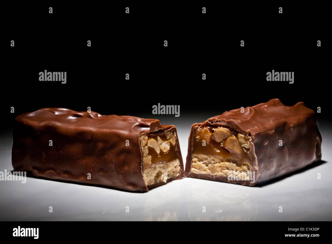 cut open chocolate candy bar in spotlight Stock Photo - Alamy