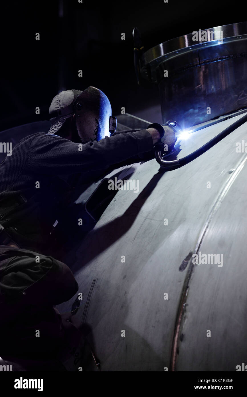 A welder welding a port on a pressure vessel Stock Photo - Alamy