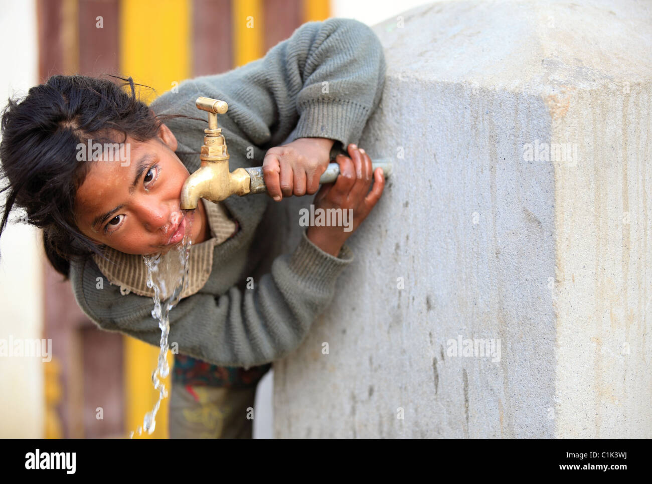 Nepali girl drinking water hi-res stock photography and images - Alamy