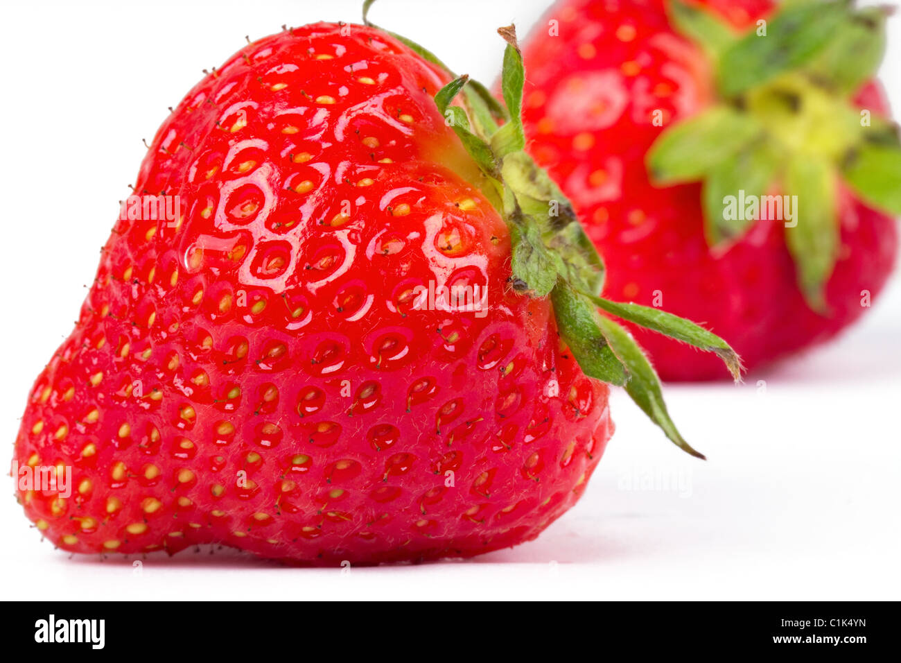 Two red strawberries isolated on white, closeup Stock Photo - Alamy