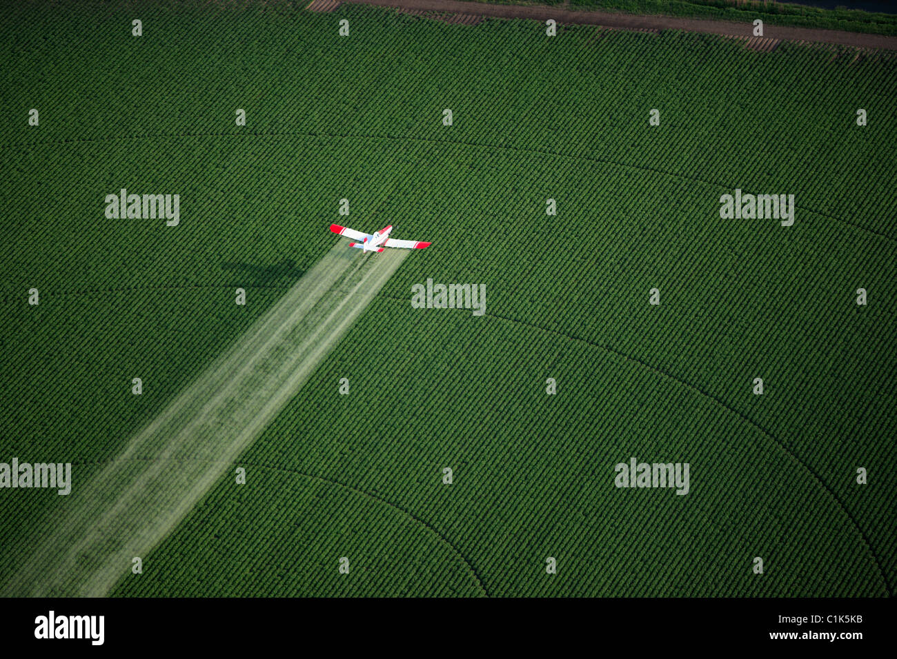 A crop duster working in a farm field Stock Photo - Alamy
