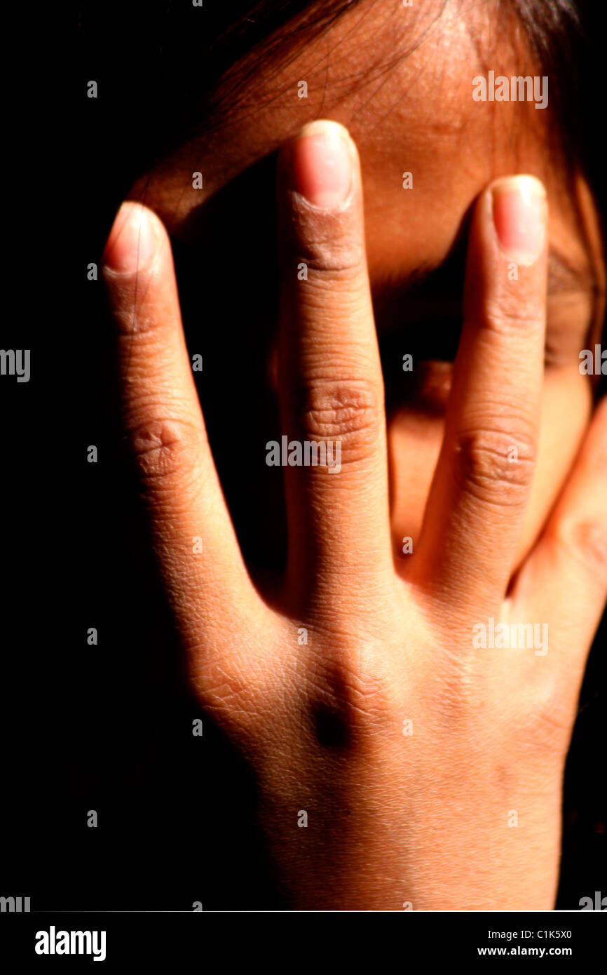 A girl covering her face with hand Stock Photo - Alamy