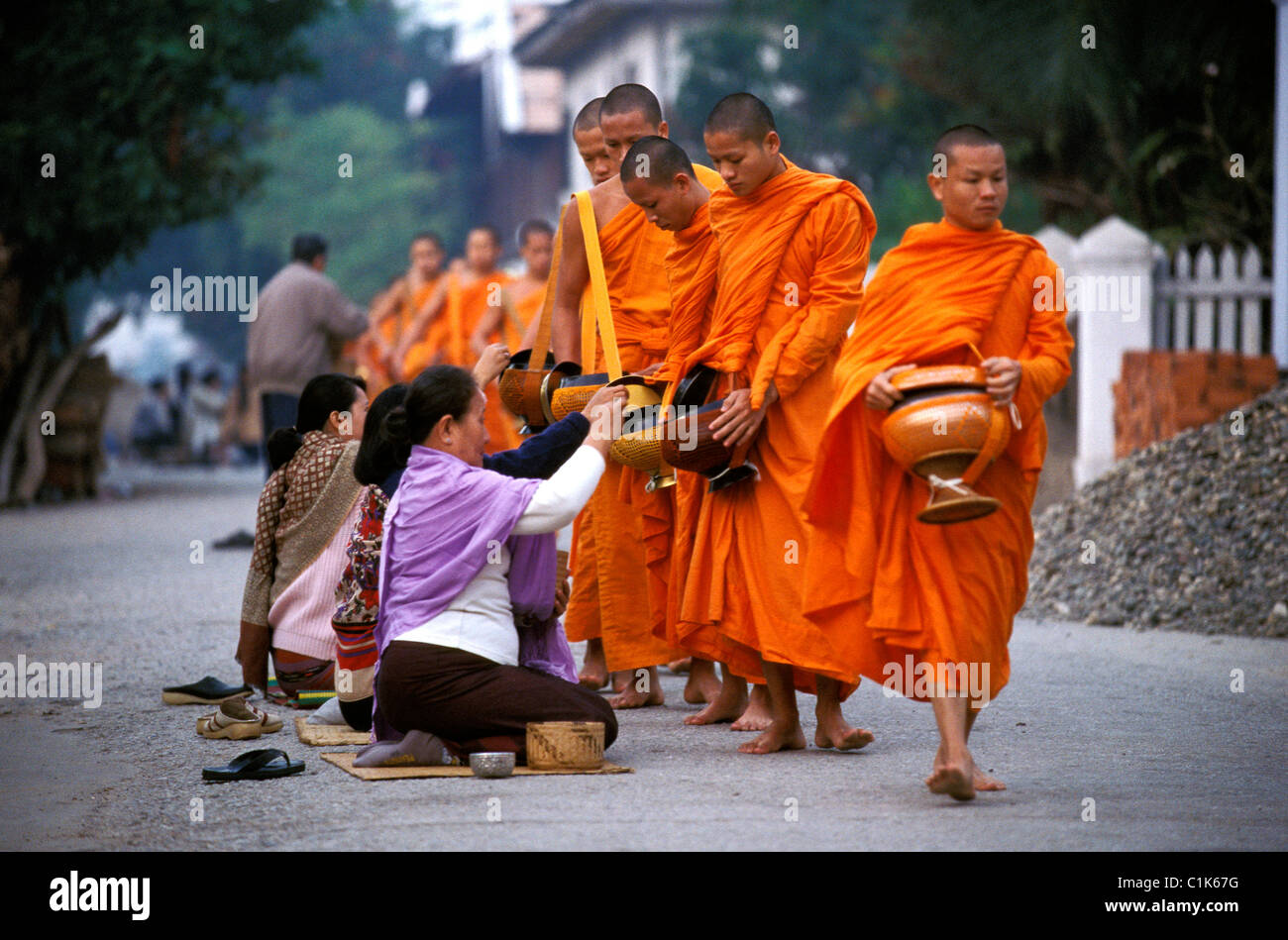 Laos, Luang Prabang, Mekong river, monks in procession for the morning ...