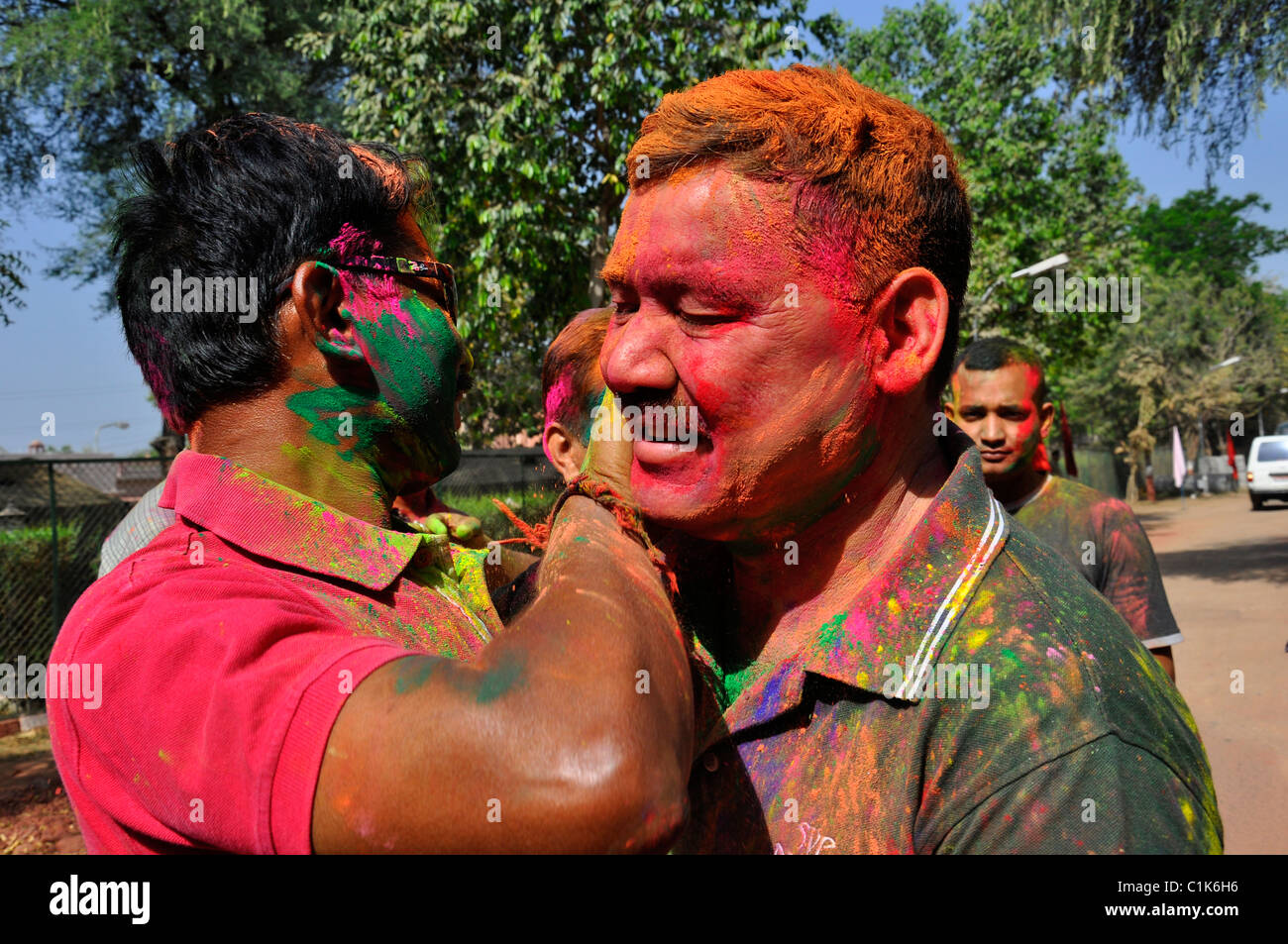 Holi festival- one Indian applying color to the face of another Stock ...