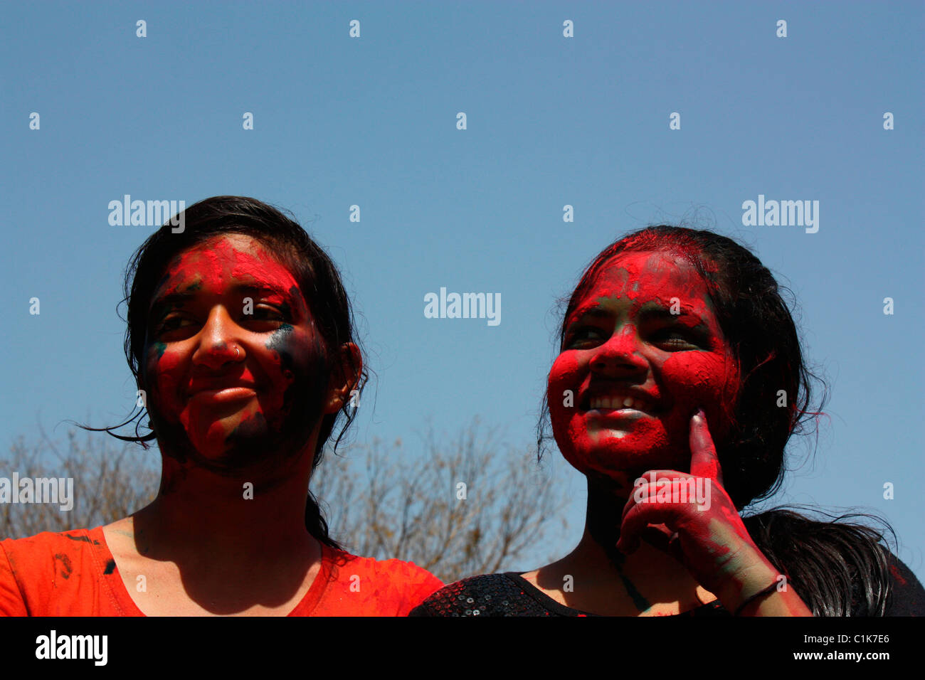 Two Indian girls playing holi Stock Photo - Alamy