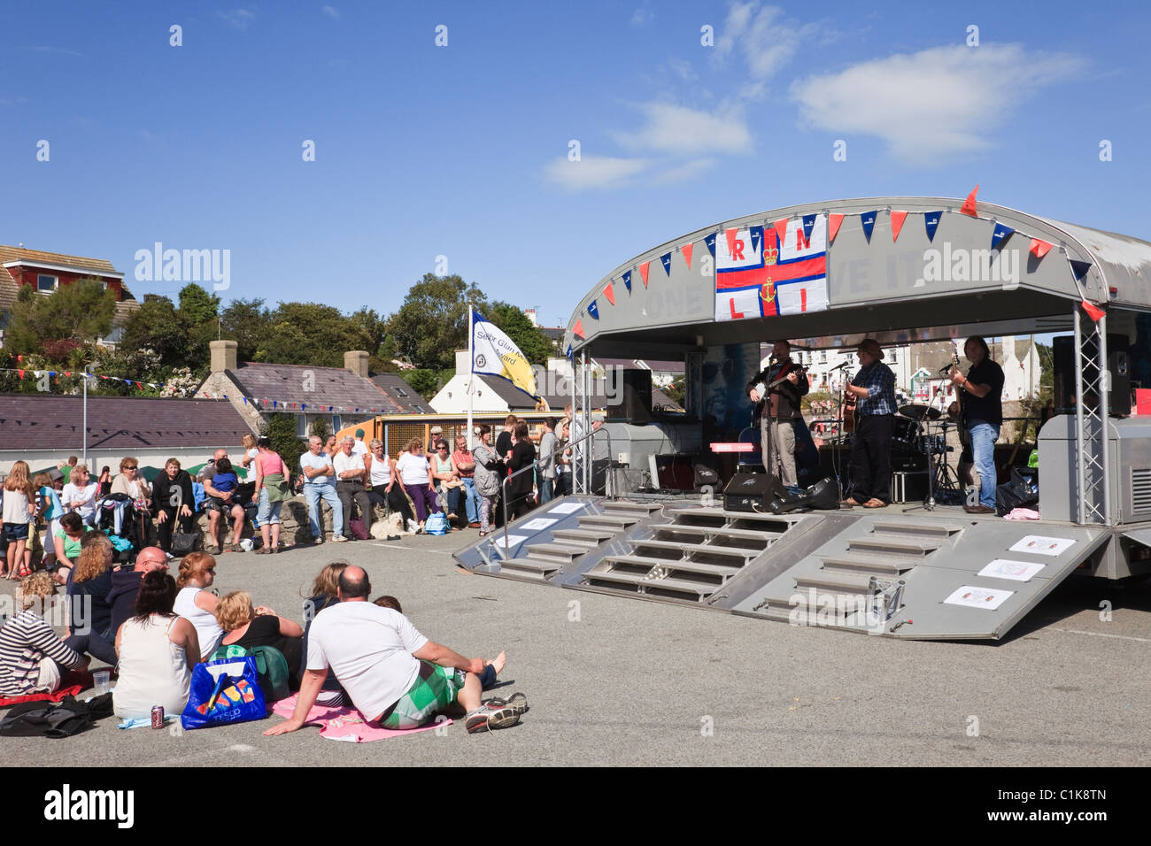 Moelfre, Anglesey, North Wales, UK. People watching a band playing ...