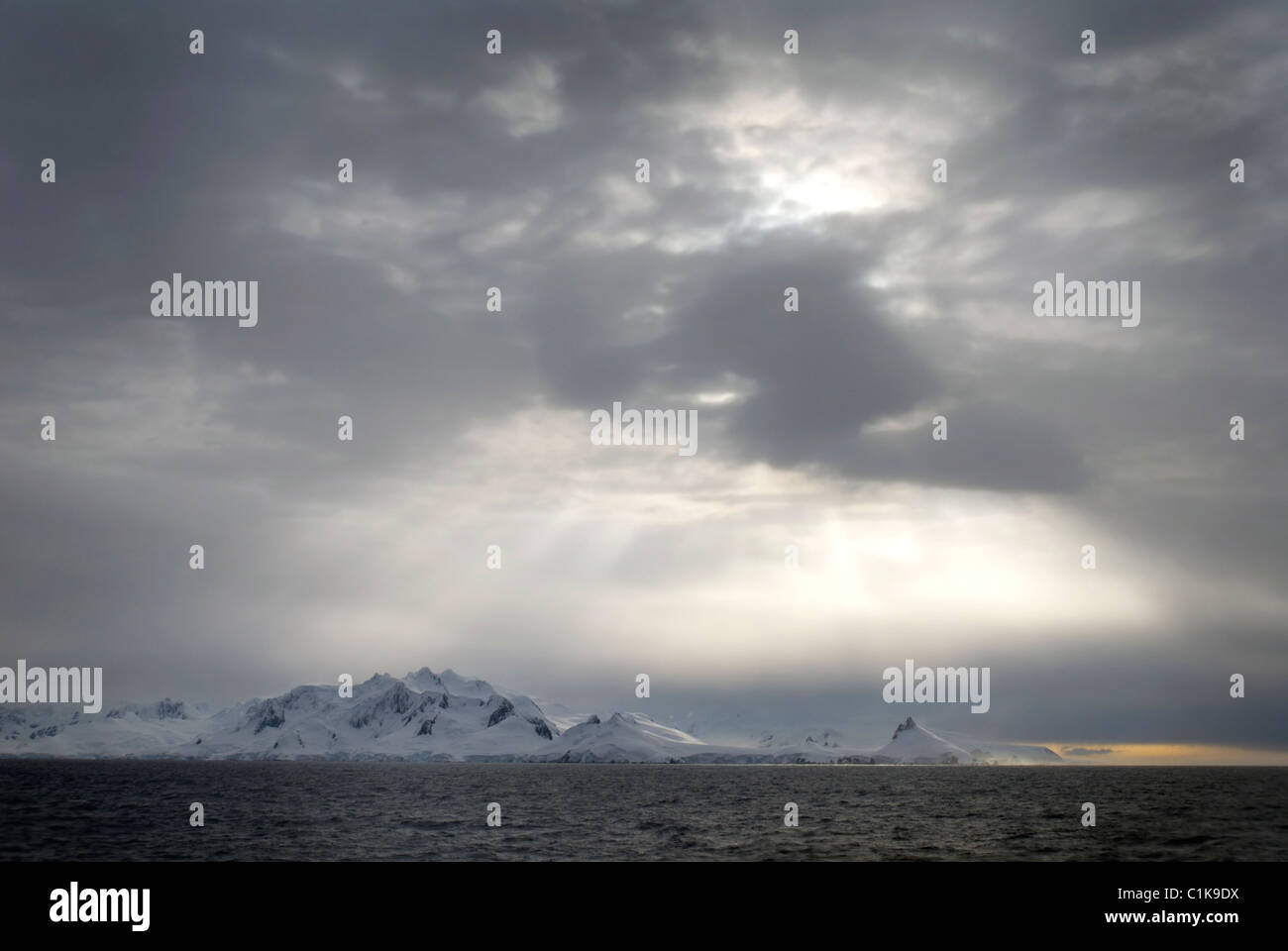 Atmospheric sky with snow capped mountains at Antarctica Stock Photo ...