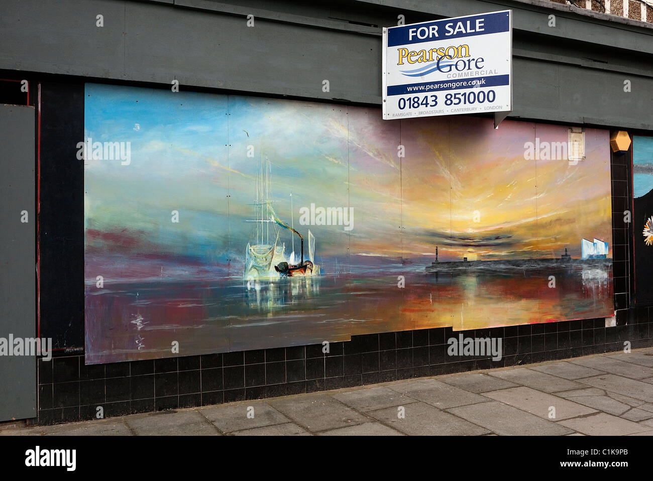 Boarded up shop in Margate Kent with Turner type mural painting on shop ...