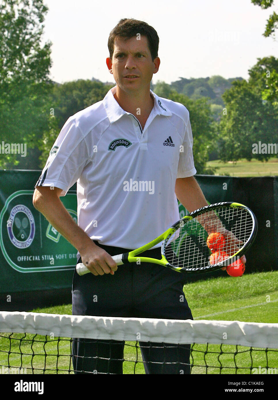 Tim Henman entertains the queueing fans at Wimbledon on the Robinson's ...