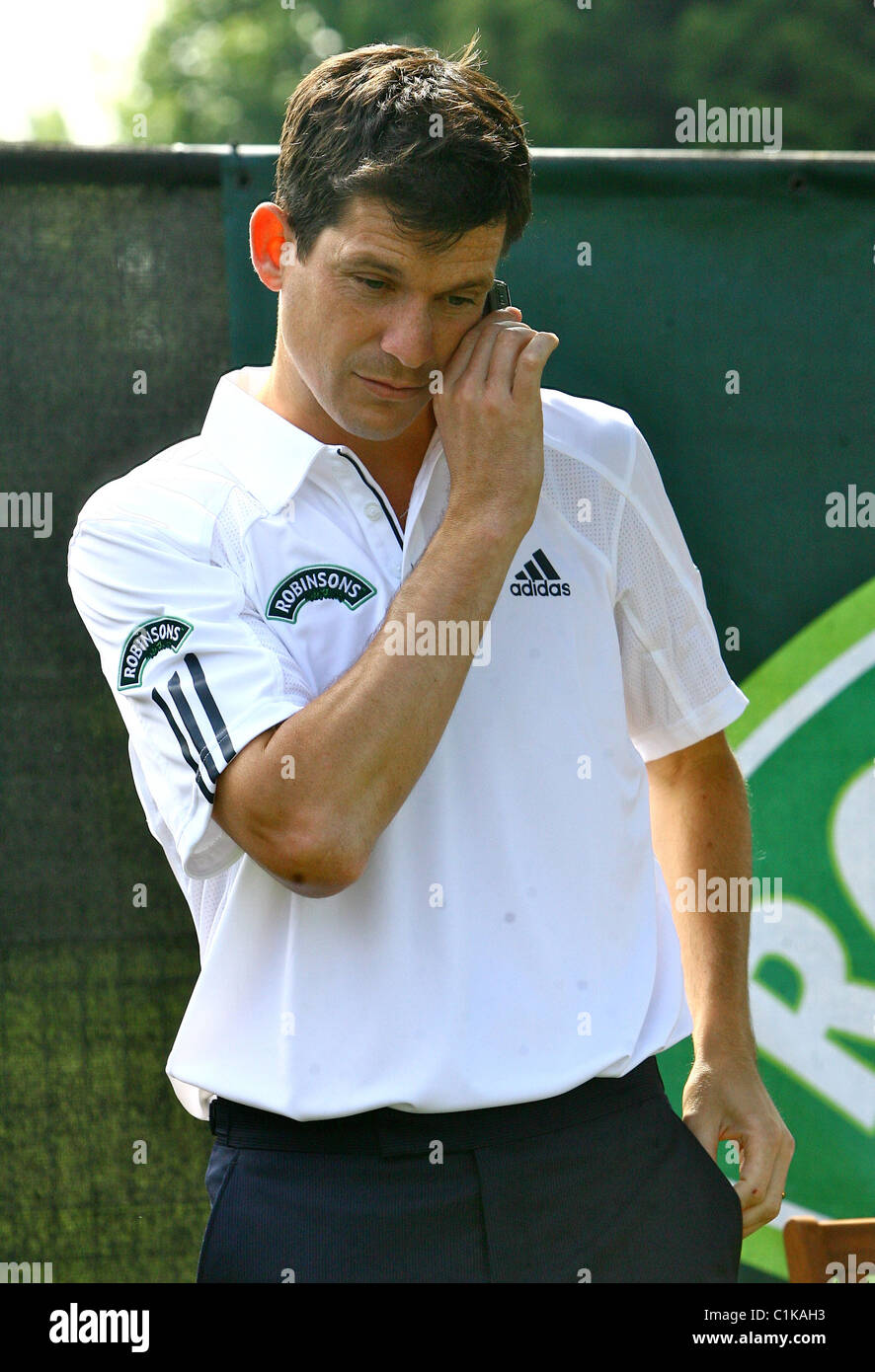 Tim Henman entertains the queueing fans at Wimbledon on the Robinson's ...