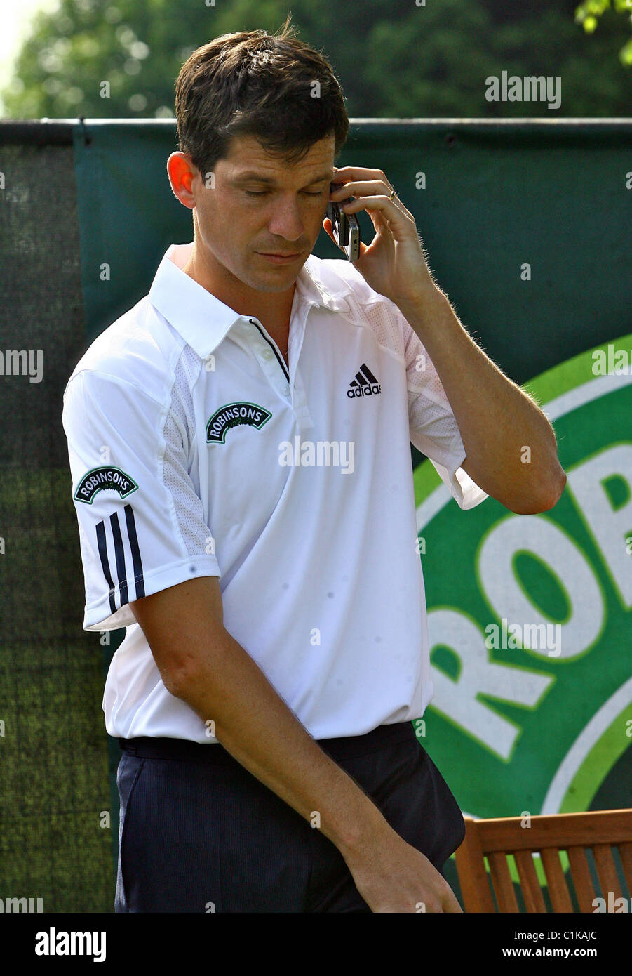 Tim Henman entertains the queueing fans at Wimbledon on the Robinson's ...