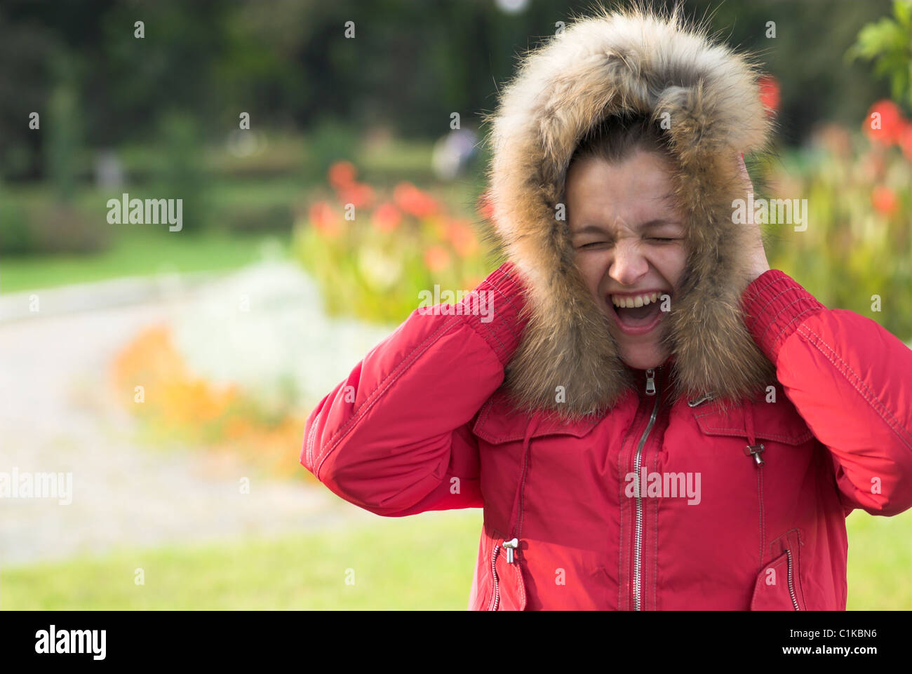 Young woman is screaming on flowered background Stock Photo - Alamy