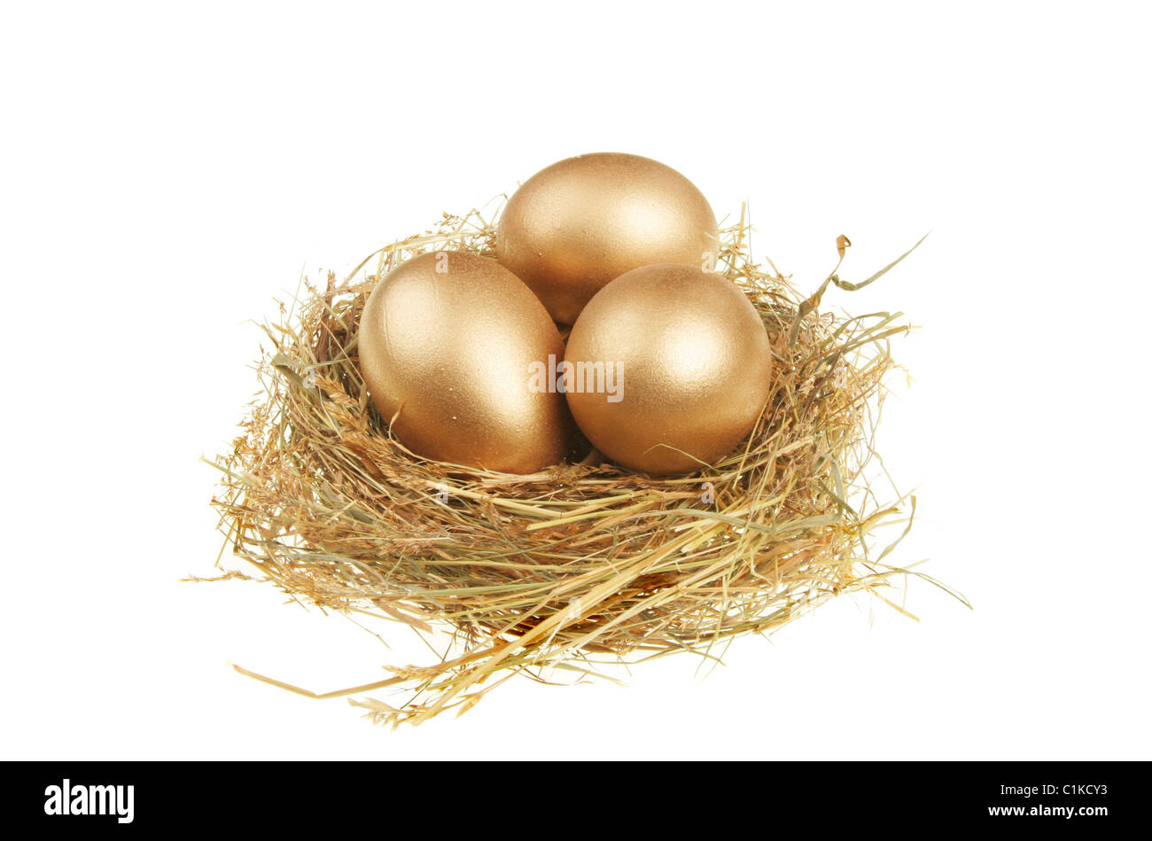 Three golden eggs in a nest of straw Stock Photo - Alamy