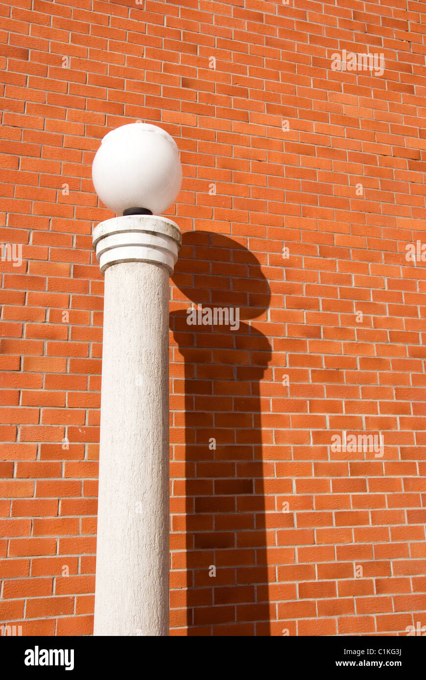 one white column with lamp and shadow Stock Photo - Alamy