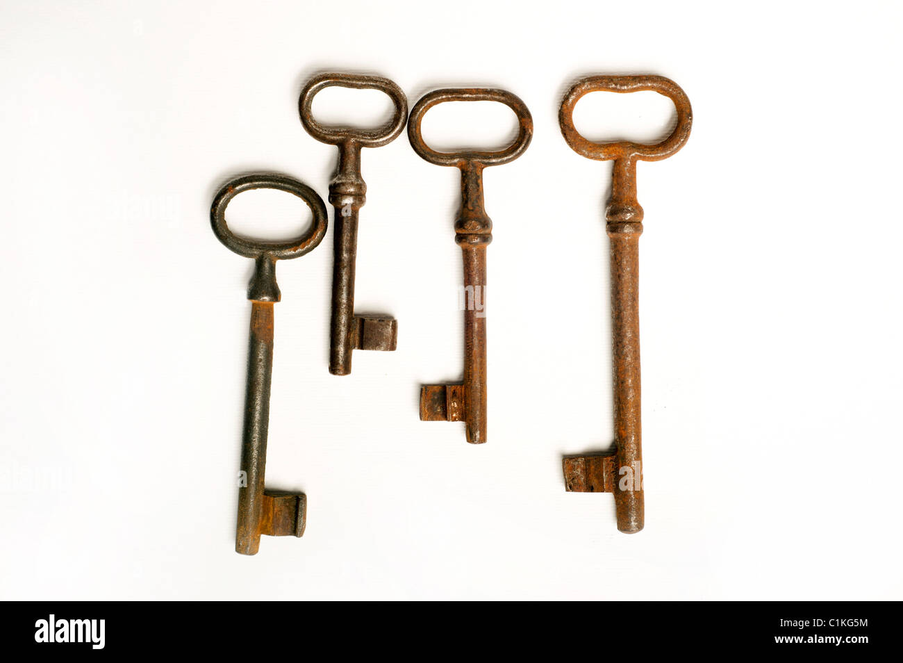 four old rusty keys isolated Stock Photo - Alamy