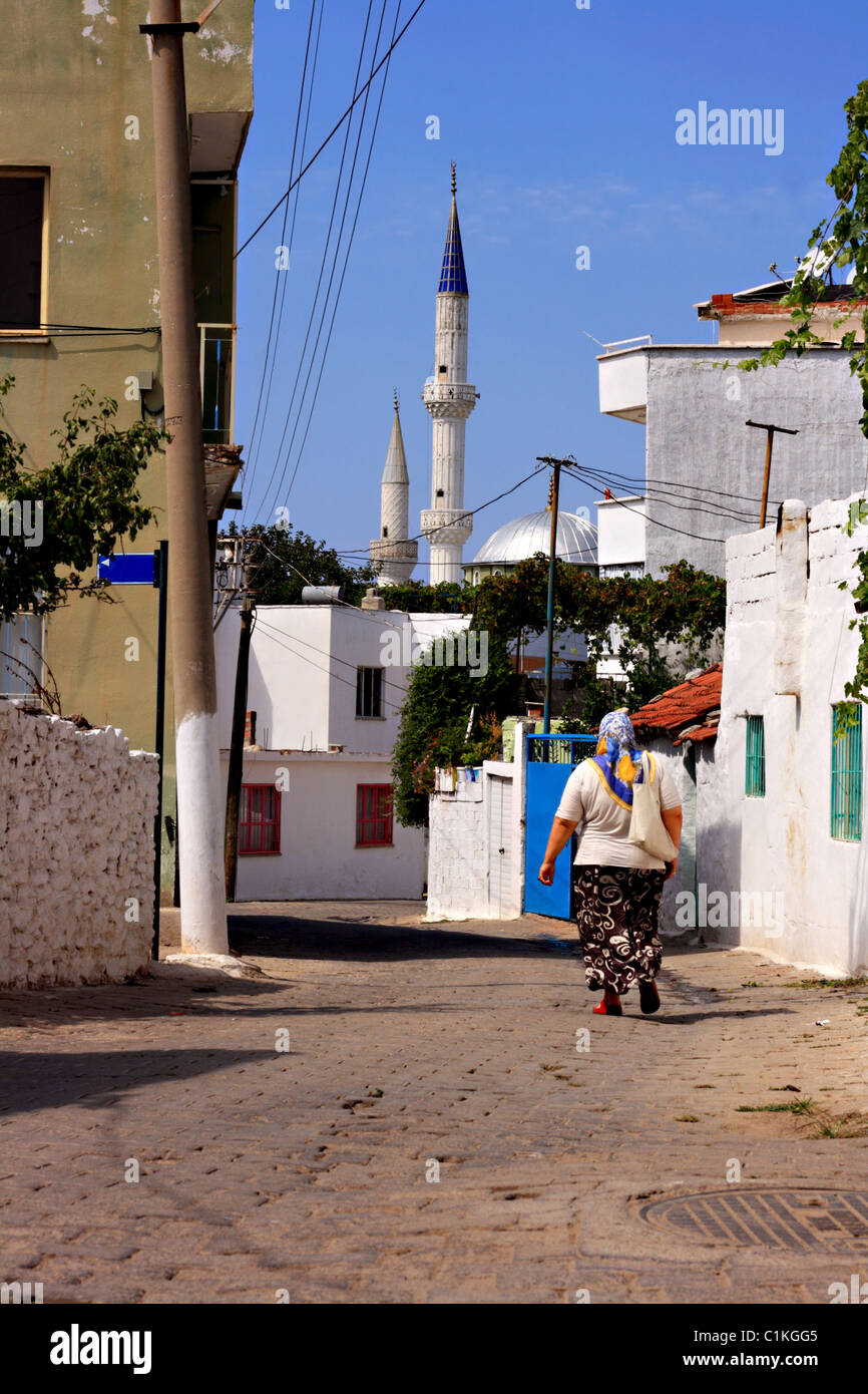 Turkish woman walking to mosque down narrow village alley Stock Photo ...